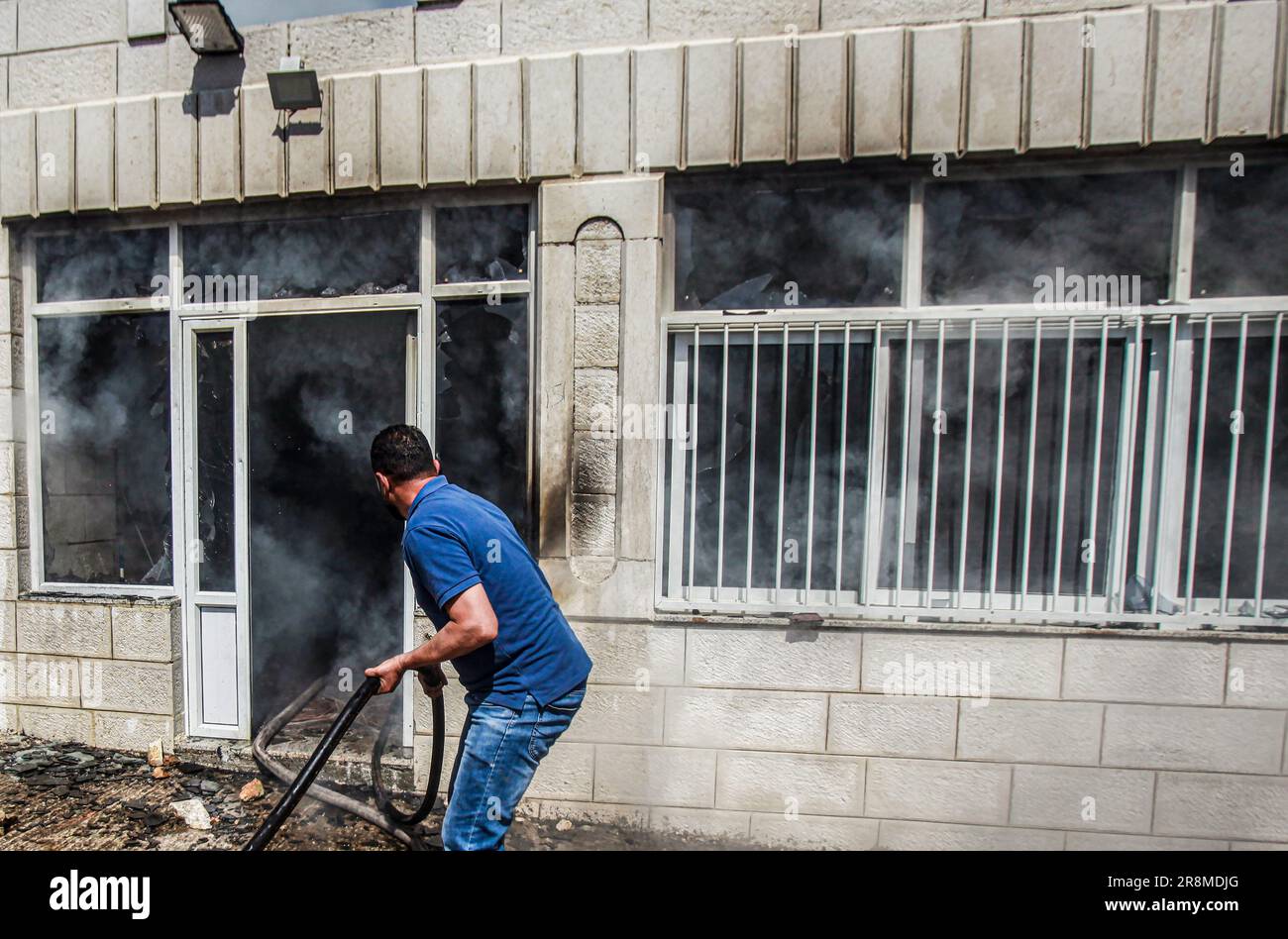 Ramallah, Palestine. 21st June, 2023. Palestinians try to extinguish a ...