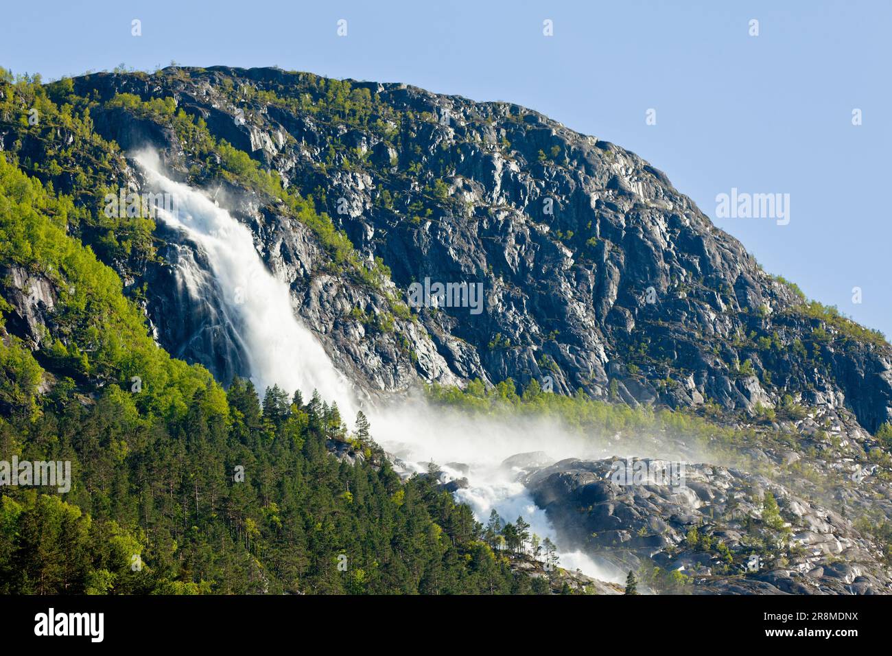 A powerful and awe-inspiring waterfall cascading down a rugged ...