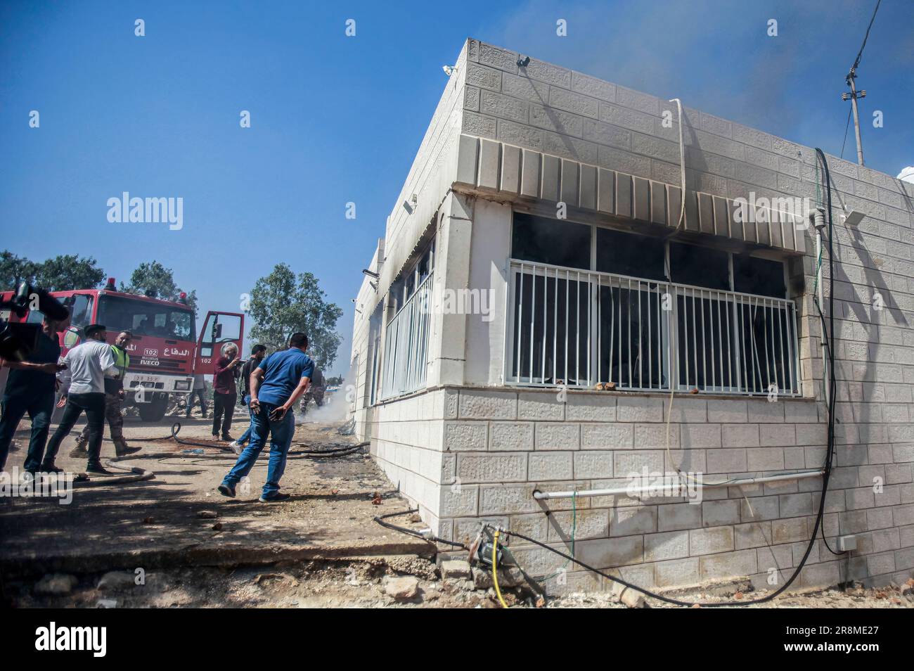 Ramallah, Palestine. 21st June, 2023. Palestinians try to extinguish a ...