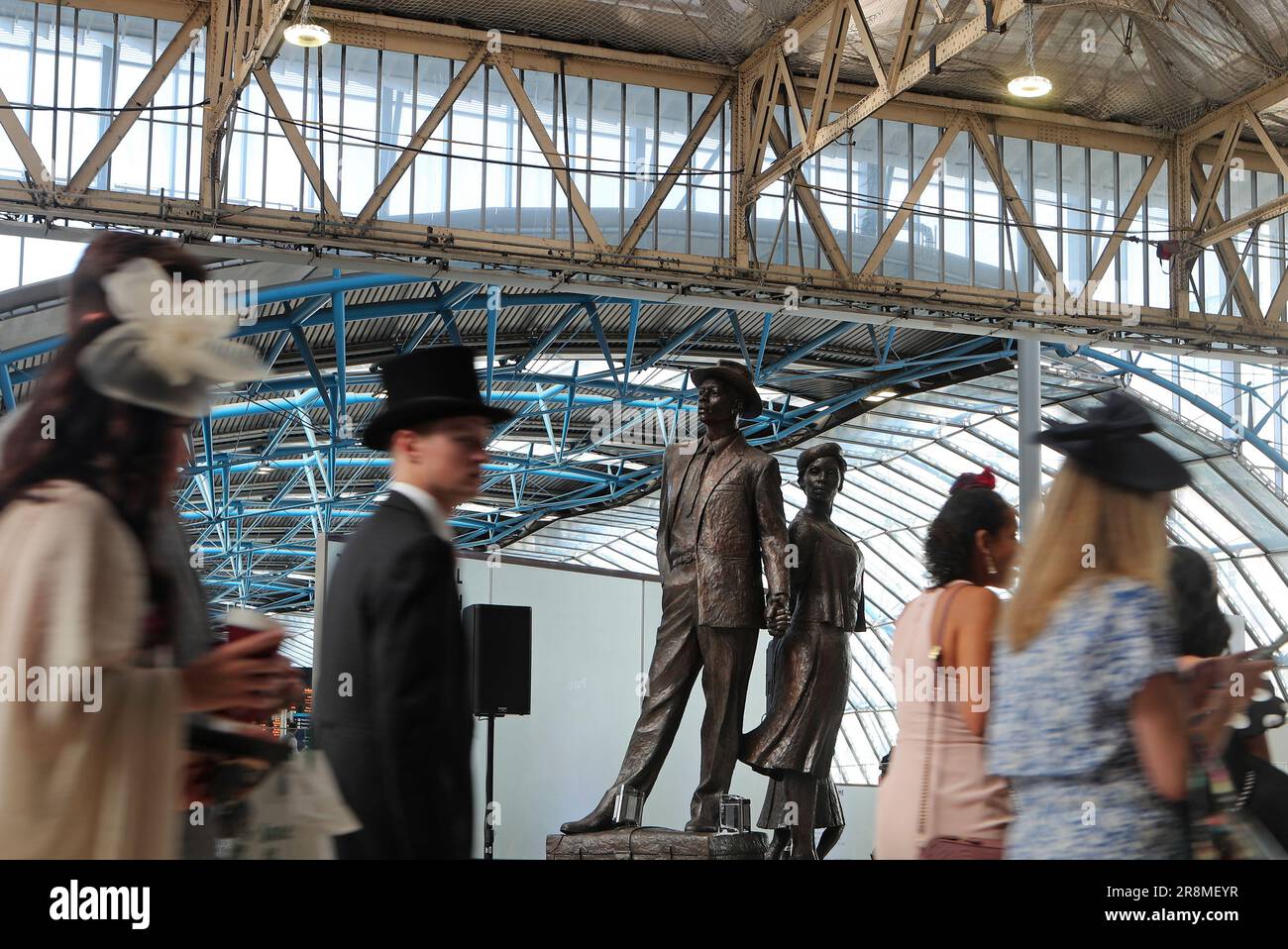 People bound for Royal Ascot race meeting walk past the National ...