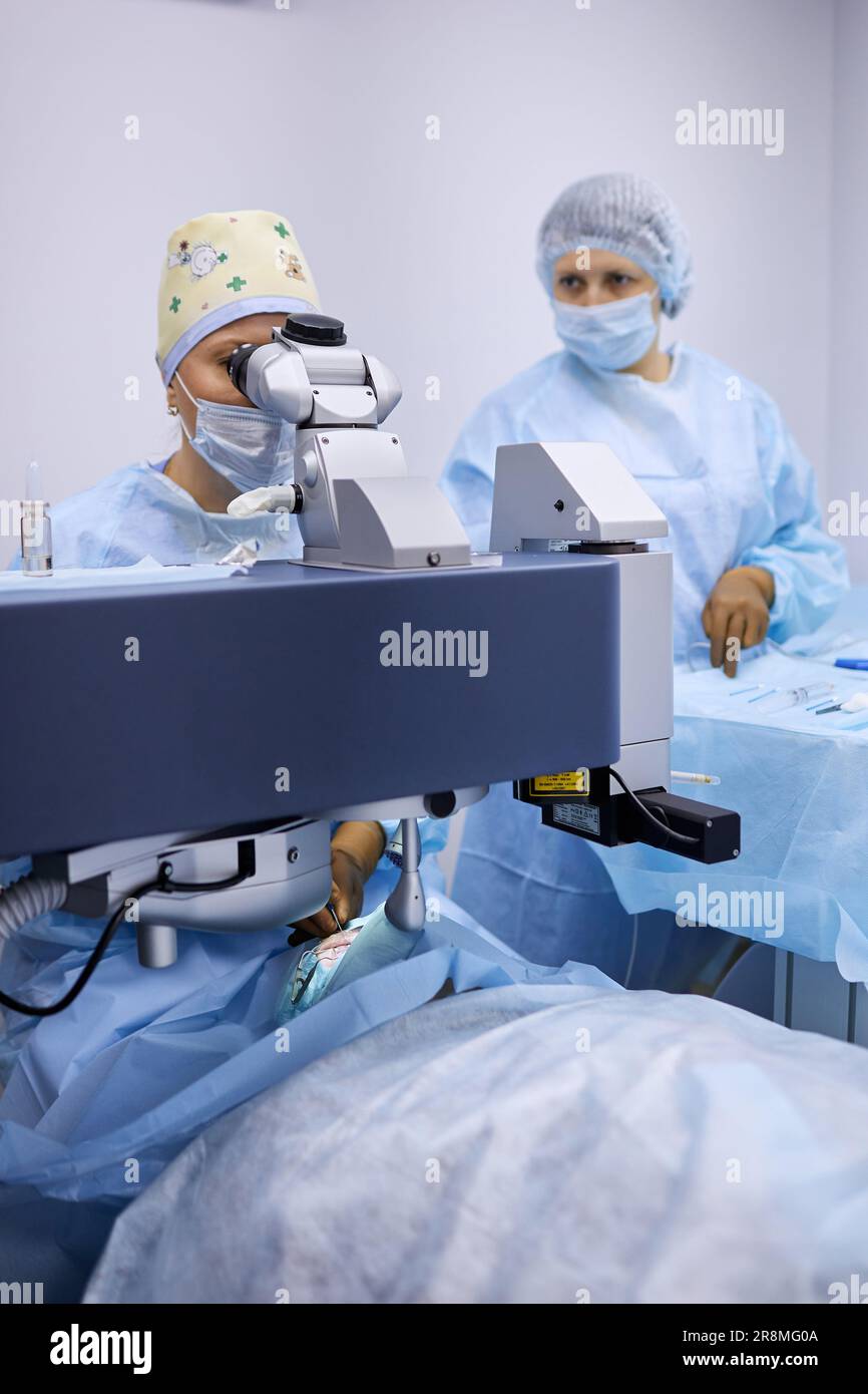 Surgeon performing eye surgery microscope hi-res stock photography and ...