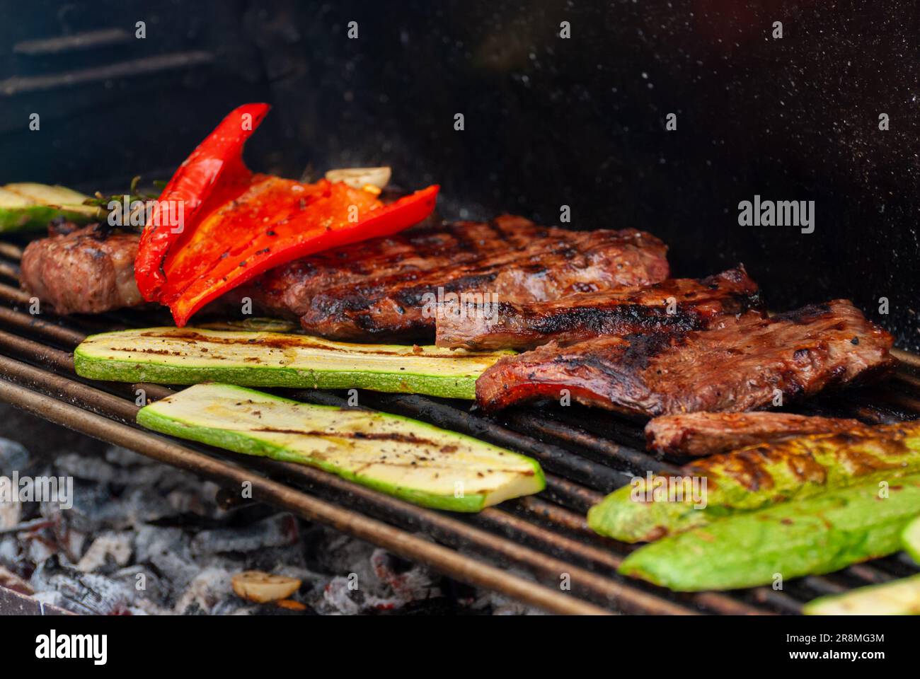 Delicious grilled meat with vegetables. grilling steaks Stock Photo - Alamy