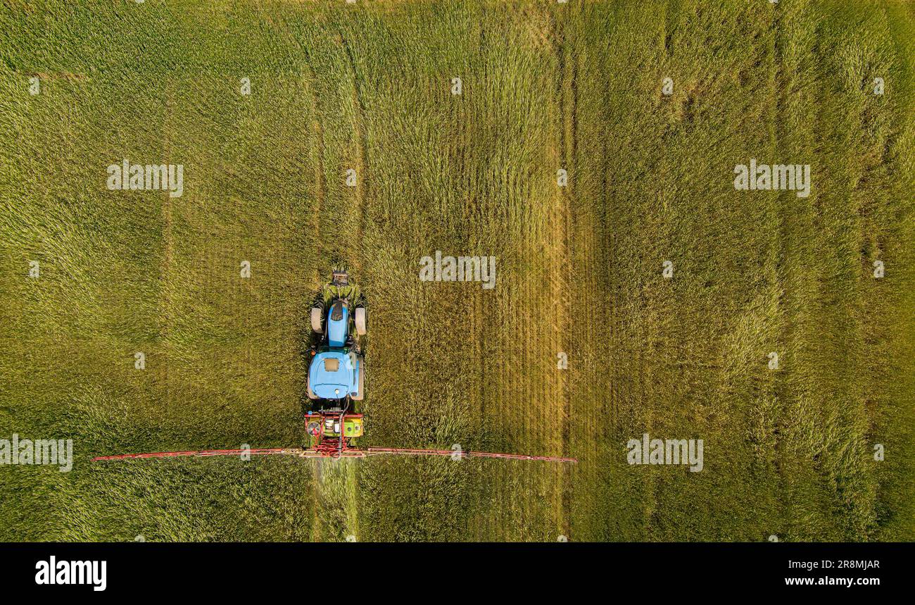 Tractor spray fertilize field with insecticide herbicide chemicals in ...