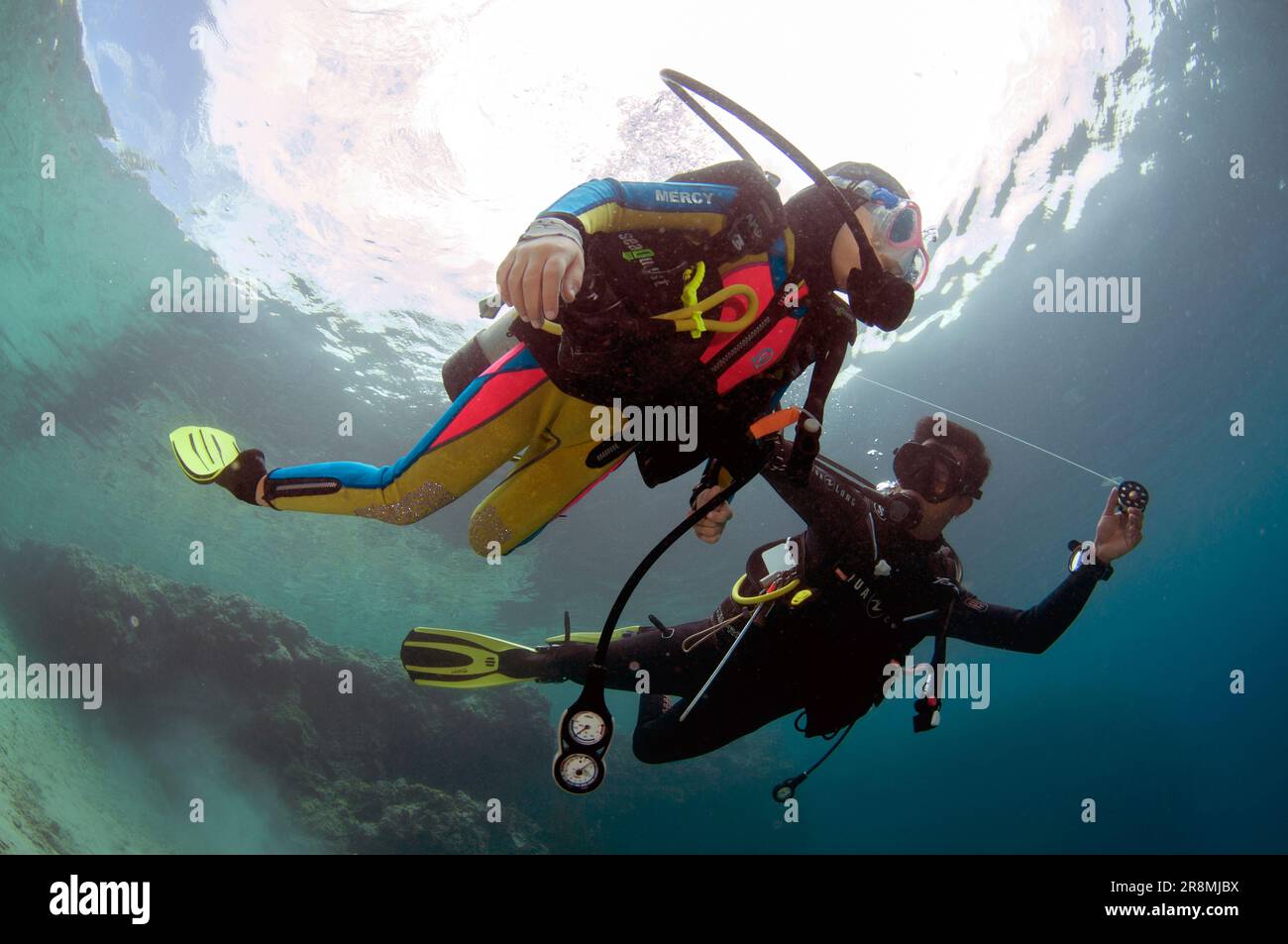 8 year-old girl diving with instructor, Post dive site, Menjangan ...