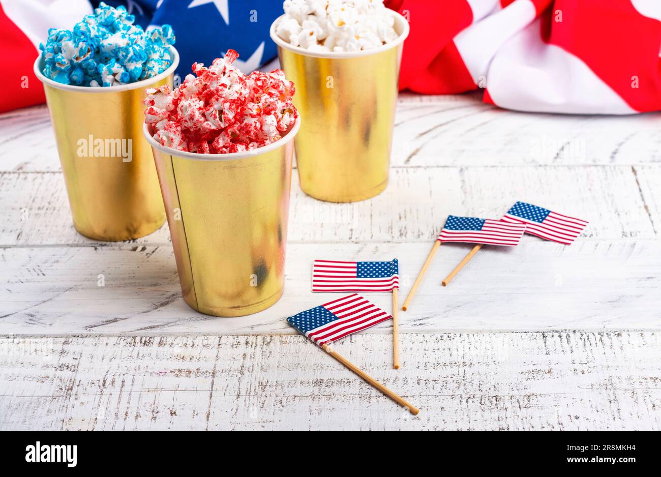 Golden paper cups with red, blue, white popcorn. US colors for 4th july ...
