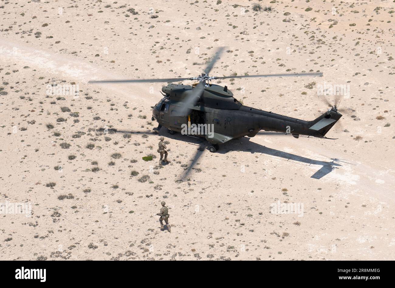 Members of the RAF Regiment return to a Puma helicopter of 84 Squadron ...