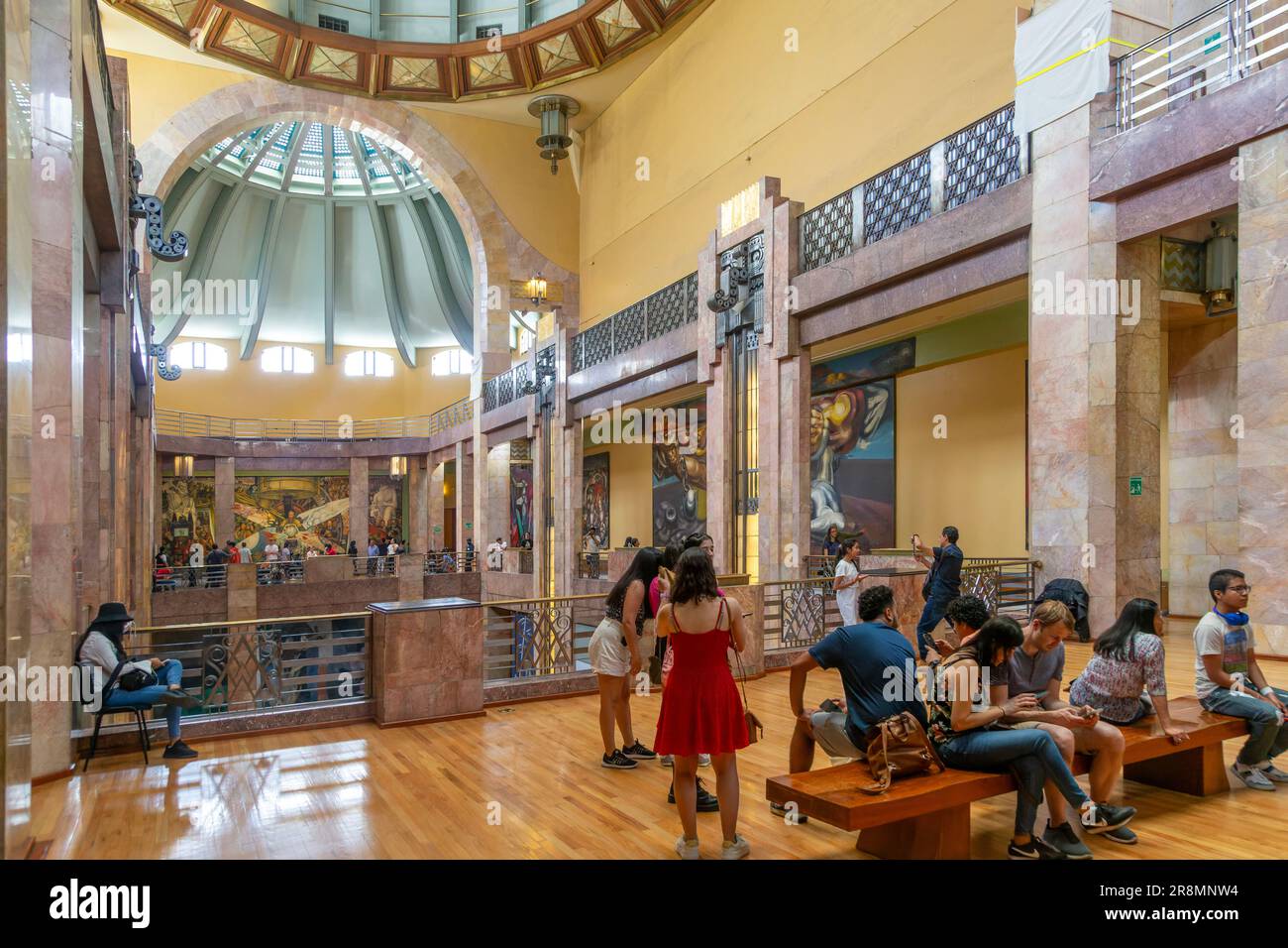 People viewing artwork murals inside Palacio de Bellas Artes, Palace of ...