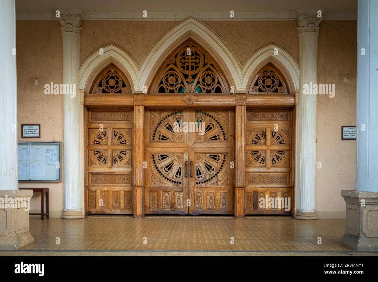Intricately carved wooden doors on the front of the Catholic Phuong ...