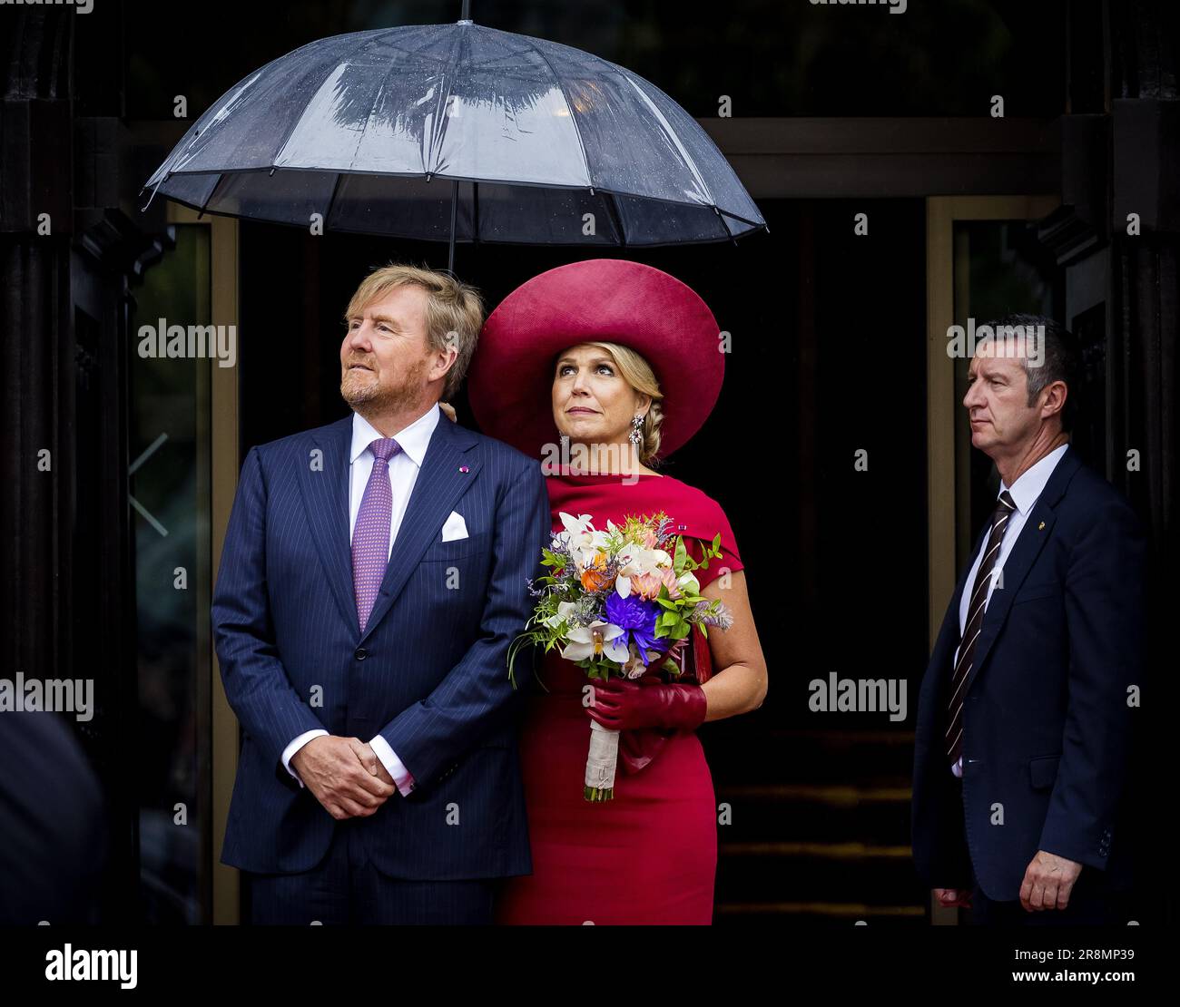 ANTWERP - 22/06/2023, King Willem-Alexander and Queen Maxima under an umbrella in the rain on ...