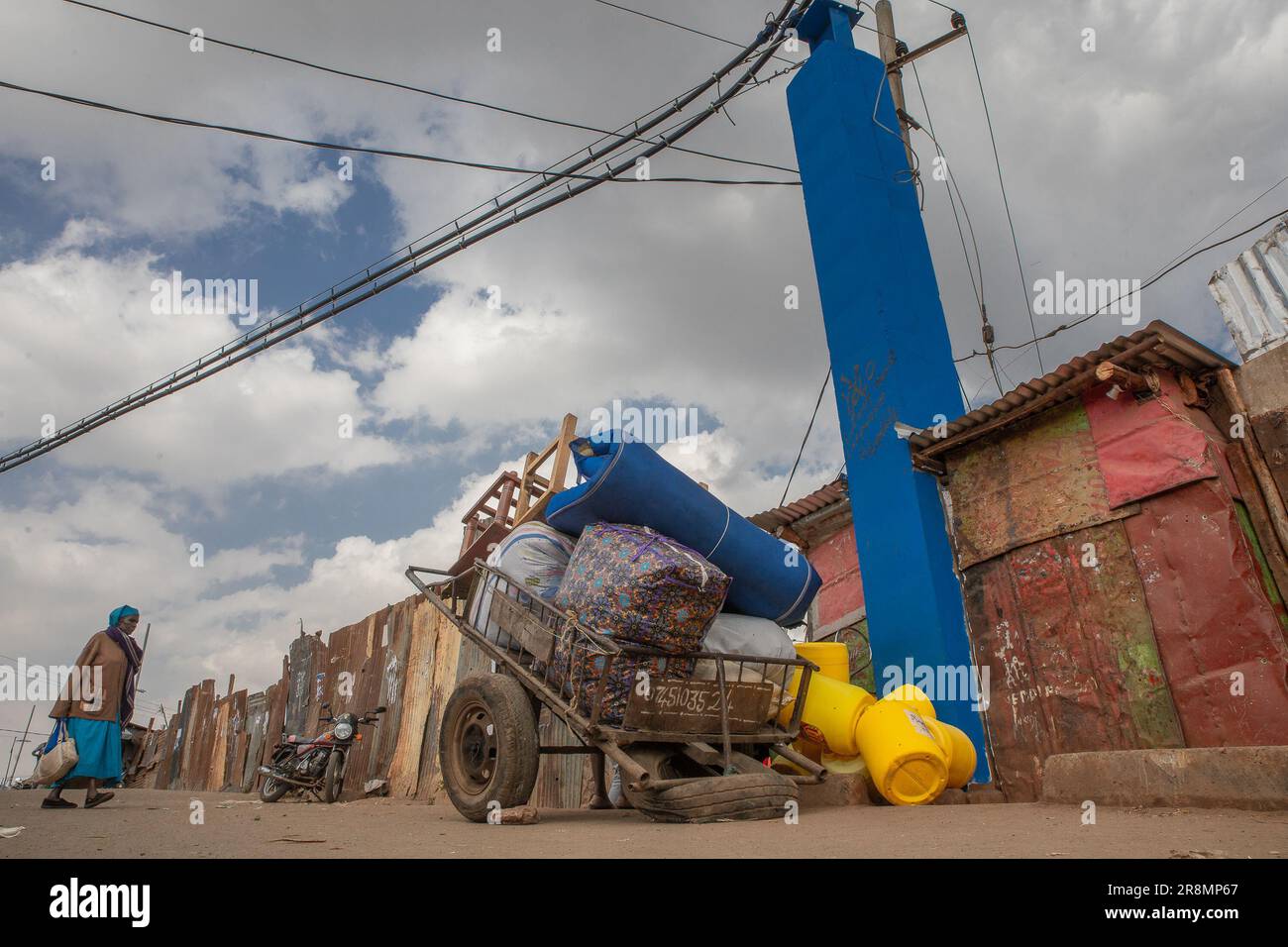 Nairobi, Kenya. 20th June, 2023. A woman walks towards a handcart ...