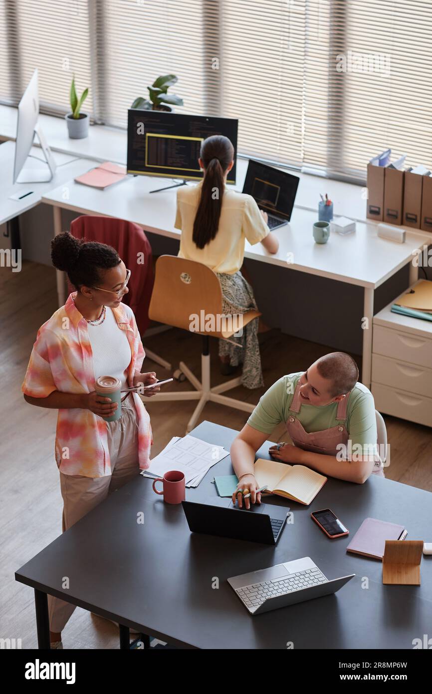 Vertical high angle portrait of all female business team working in ...