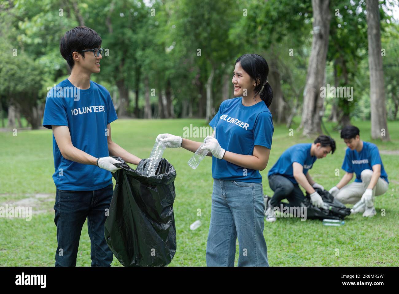 Volunteers collect litter, teenager smiling, environmental and ...
