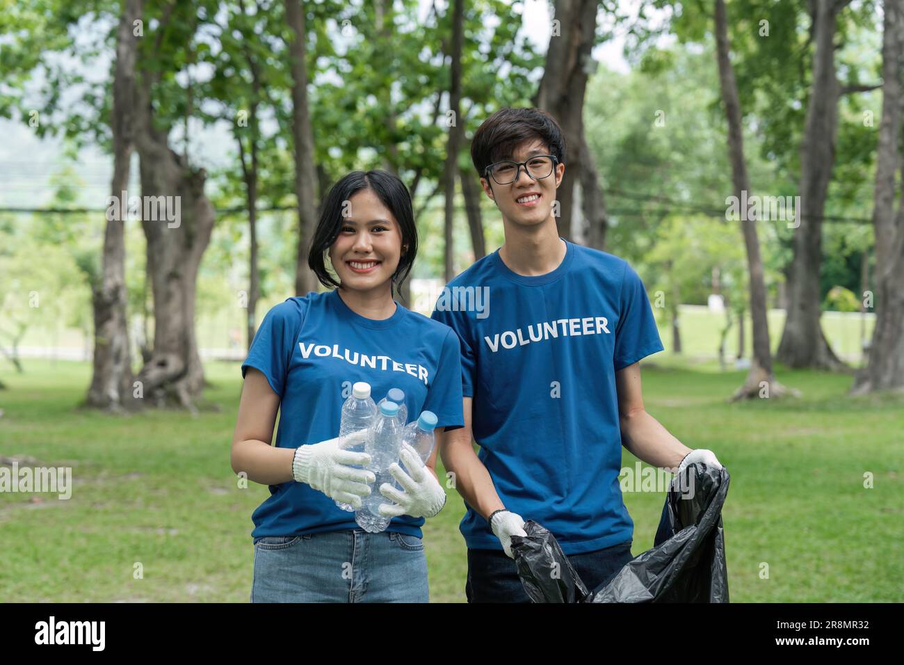 Volunteers collect litter, teenager smiling, environmental and ...