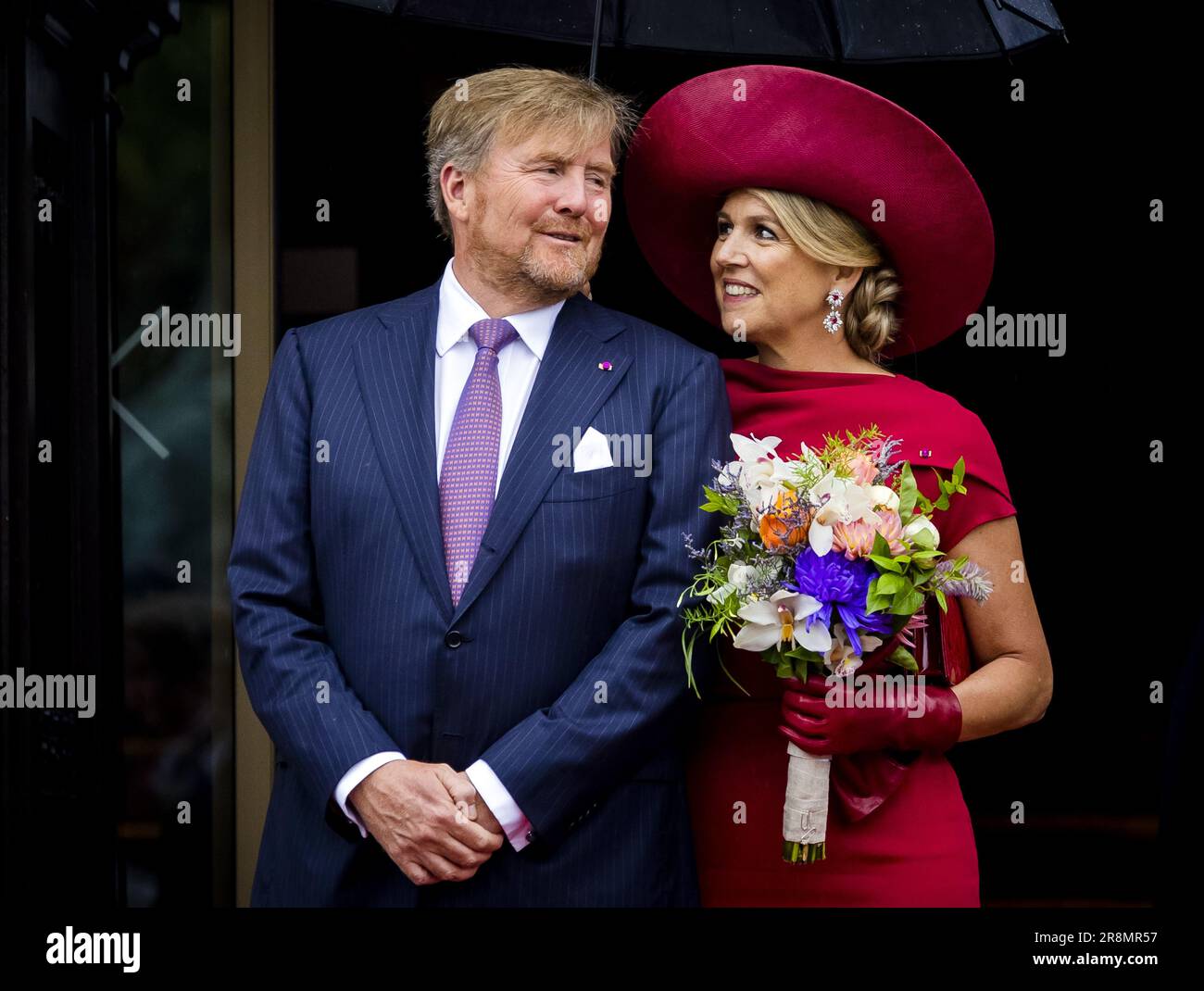 ANTWERP - 22/06/2023, King Willem-Alexander and Queen Maxima under an umbrella in the rain on ...