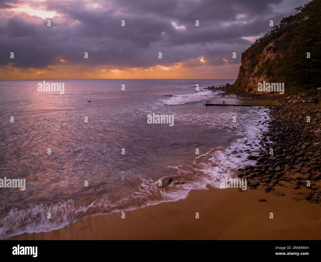 Aerial sunrise seascape with rain clouds and small waves at Macmasters ...