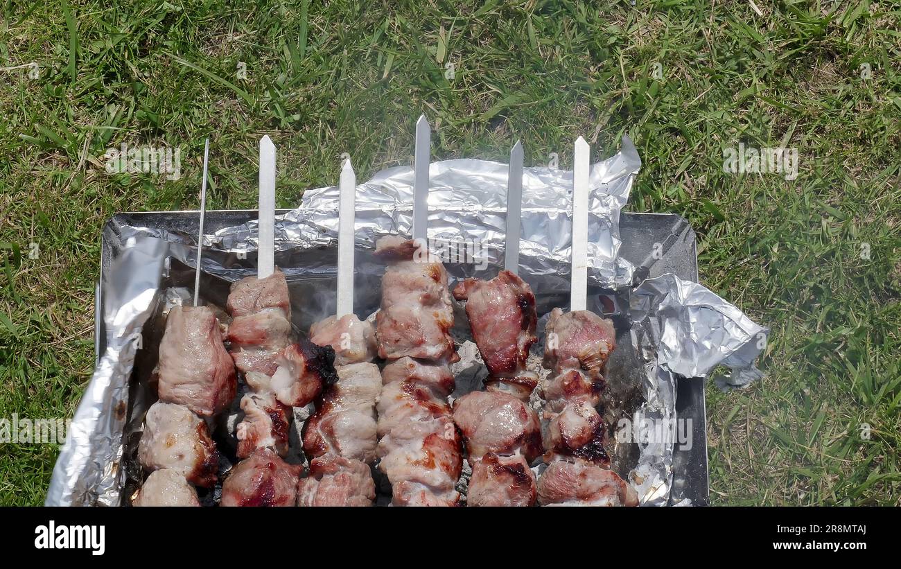 Barbecue grill with fire on nature, outdoor, close up Stock Photo - Alamy
