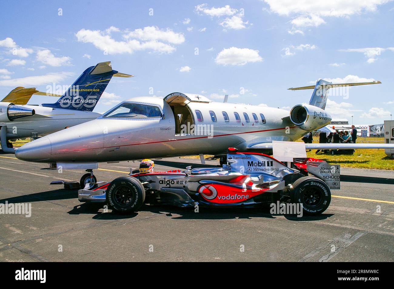 Lewis Hamilton at a press event with McLaren F1 car and Vistajet ...