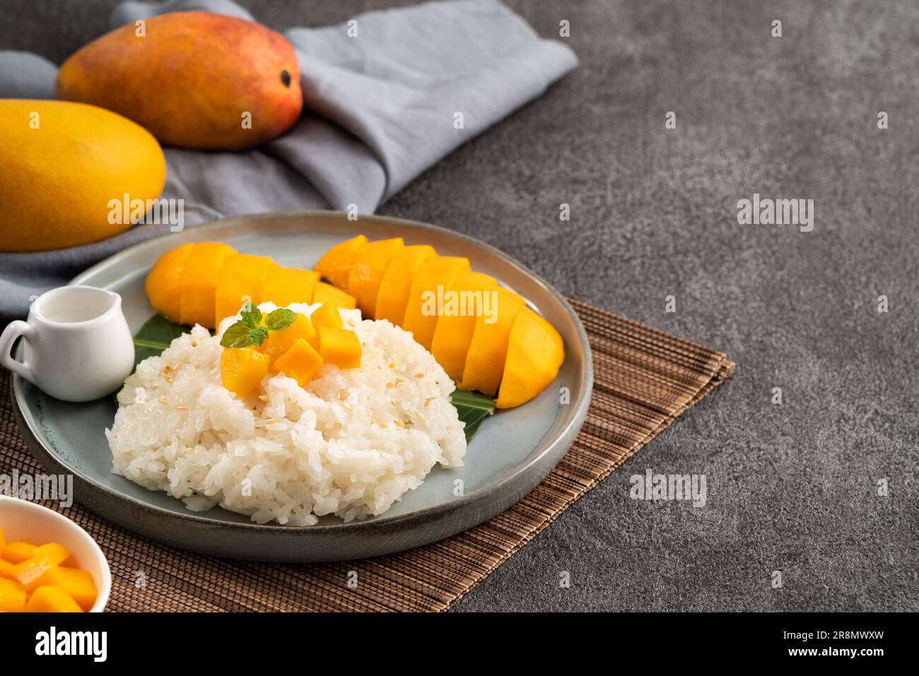 Delicious Thai mango sticky rice with cut fresh mango fruit in a plate ...