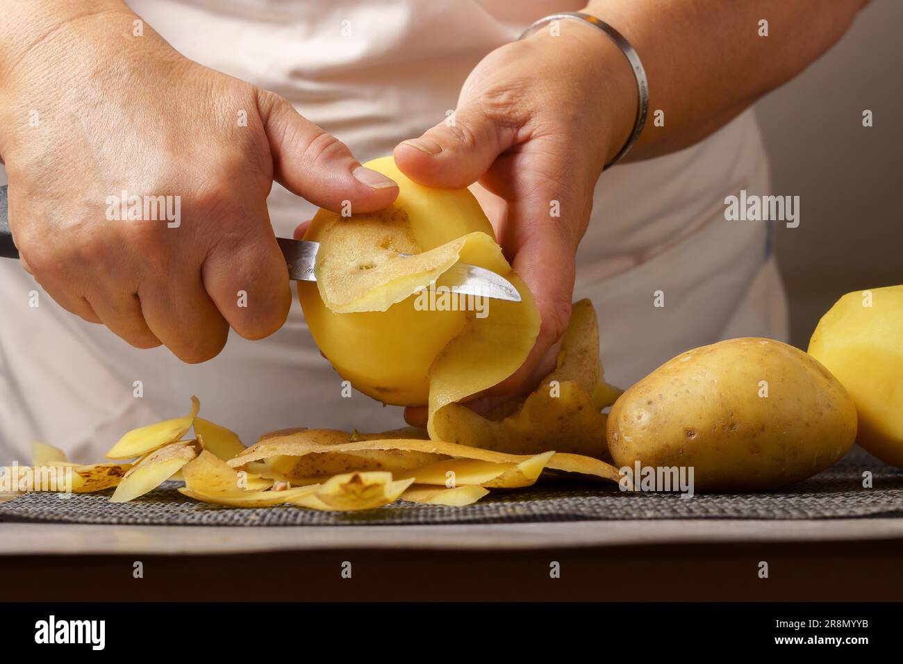 Womans hands peeling potatoes in hi-res stock photography and images ...