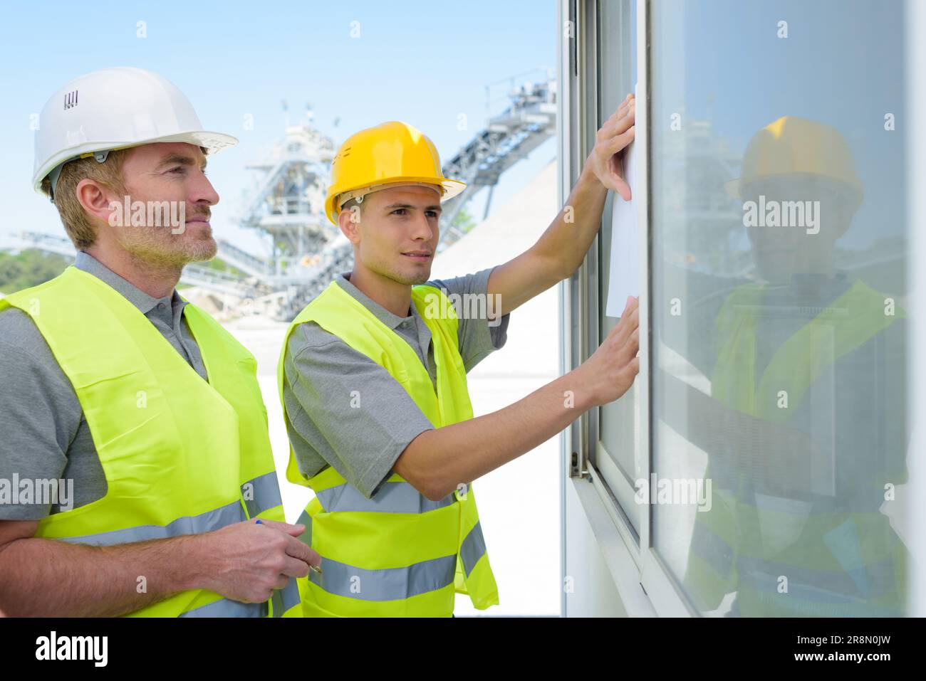 two men are working inside of apartment Stock Photo - Alamy