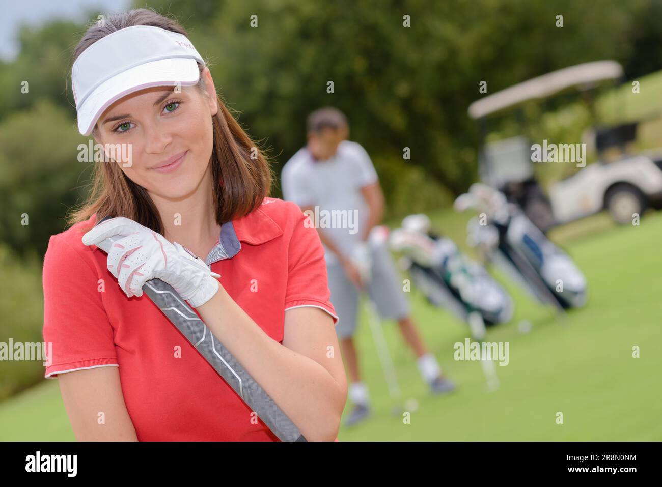 a beautiful woman playing golf Stock Photo - Alamy
