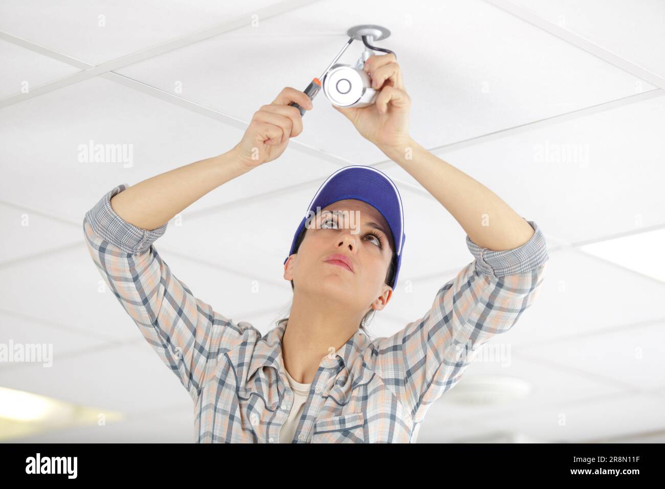 woman installing cctv on ceiling Stock Photo - Alamy