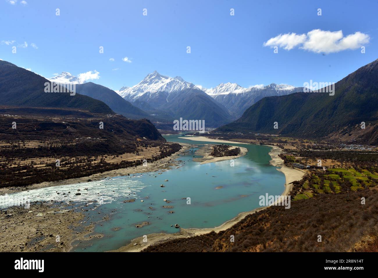 A stunning turquoise river winding through a valley, surrounded by ...