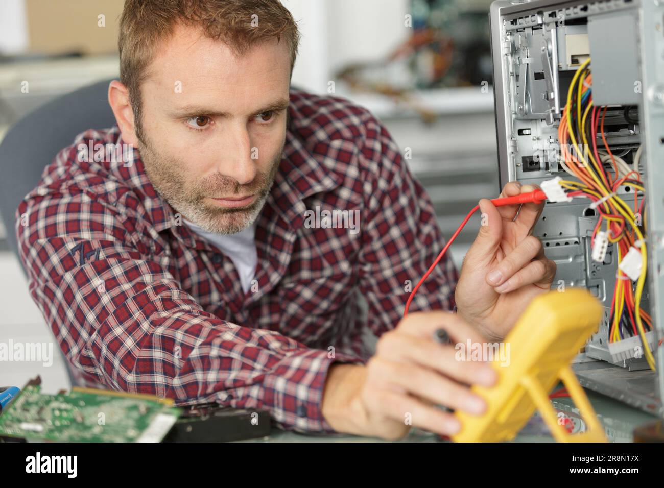 a handsome repairman repairing computer Stock Photo - Alamy