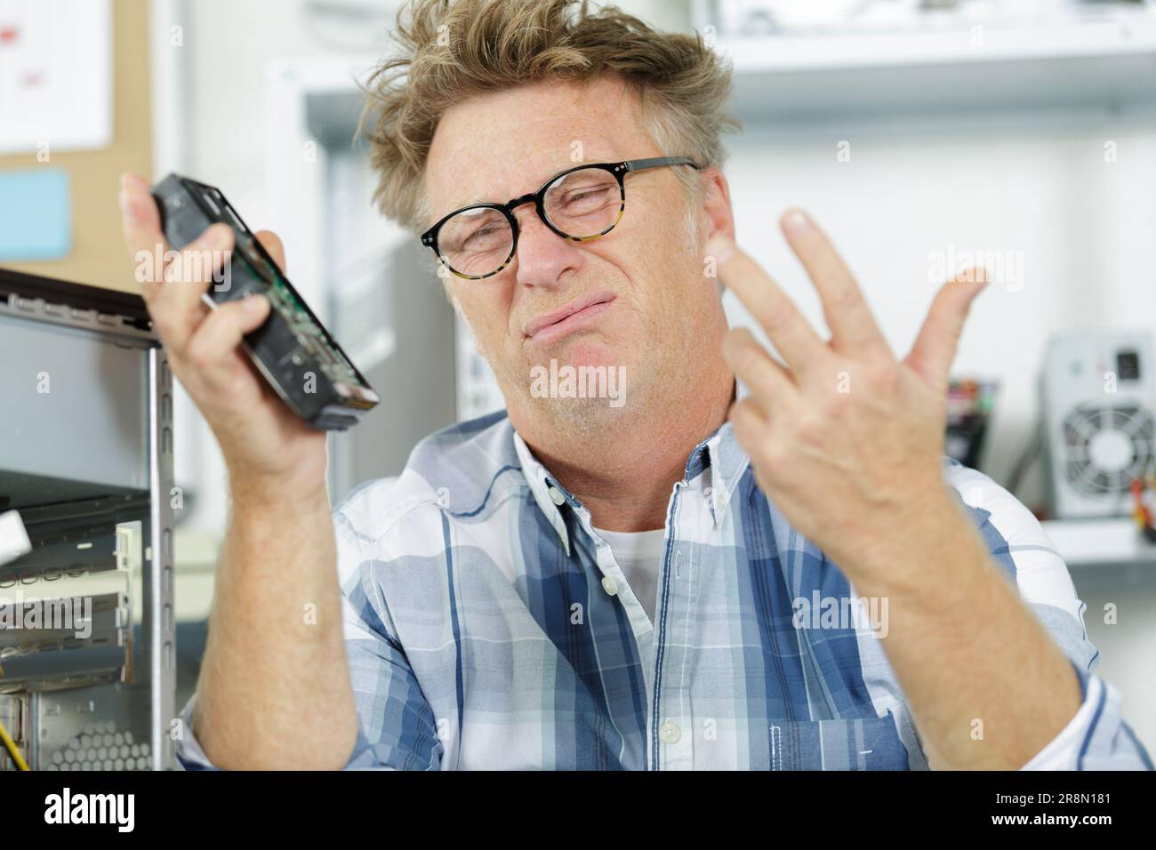 man desperate repairing broken laptop computer Stock Photo - Alamy