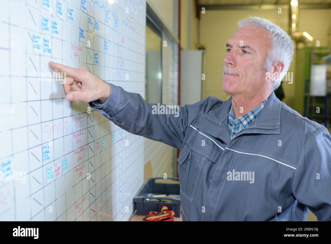 mature male worker checking his planning before the shift Stock Photo ...