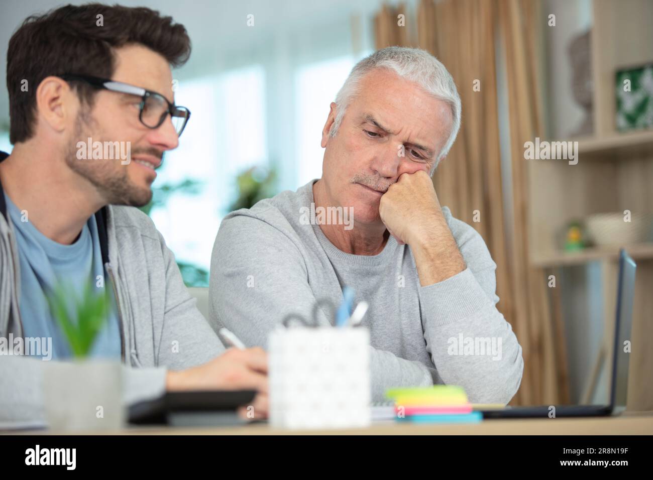 senior father and mature son checking paperwork Stock Photo - Alamy