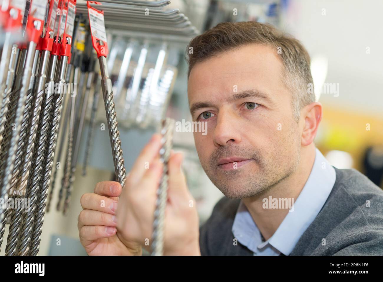 male customer buying working tools in supermarket Stock Photo - Alamy