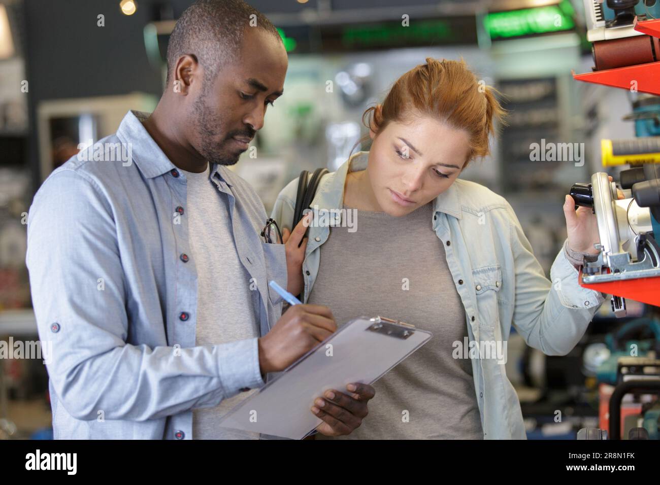 hardware store seller talking to customer Stock Photo - Alamy