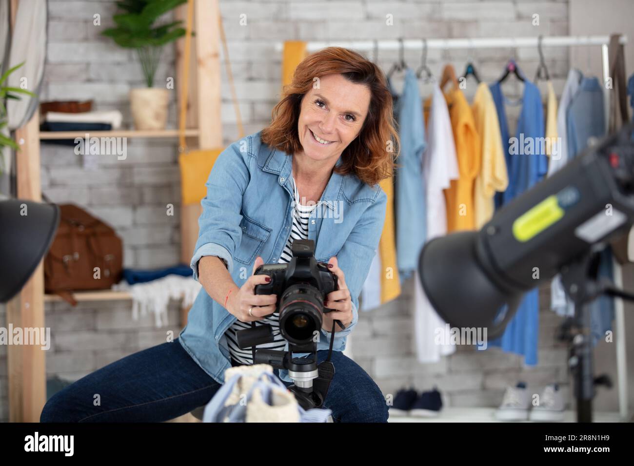 mature photographer taking shots of shoes in a studio Stock Photo - Alamy