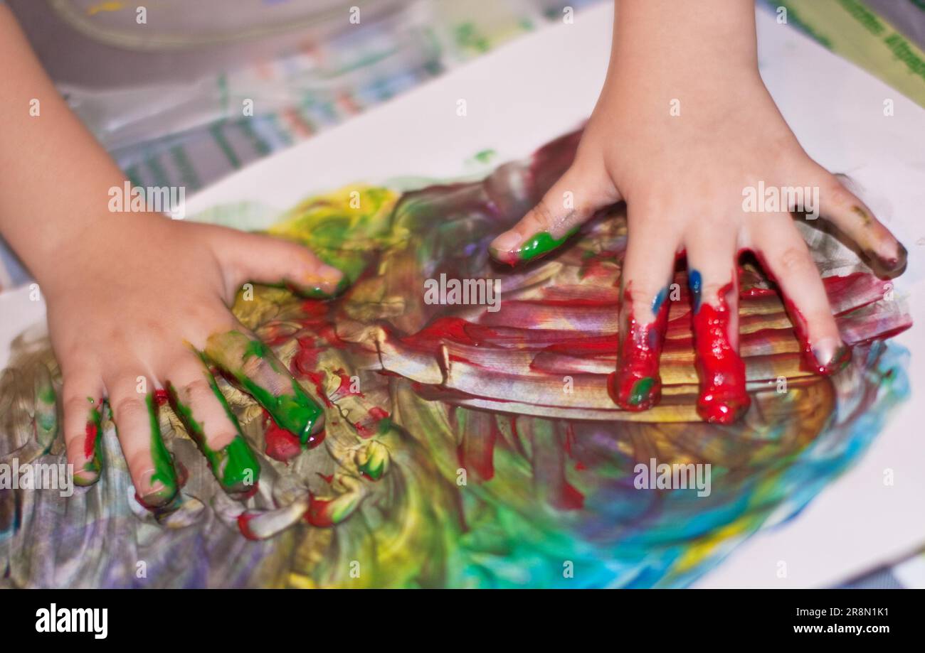 Small children's hands finger painting with different colours Stock ...