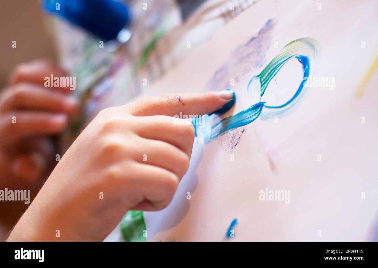 Small children's hands finger painting with different colours Stock ...