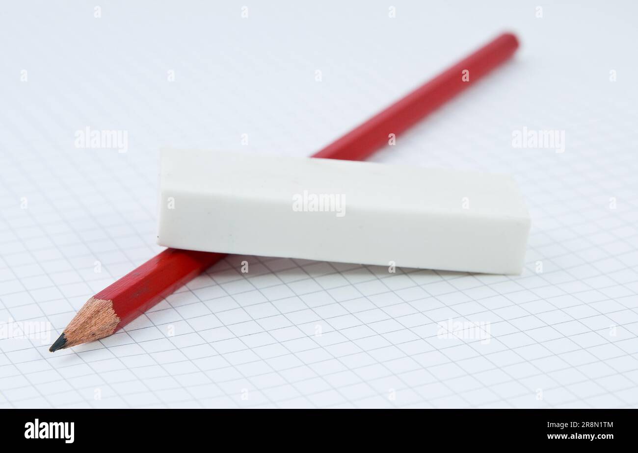 Pencil and eraser on a squared white sheet of paper Stock Photo - Alamy