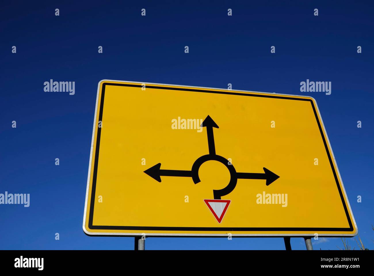 Signpost for the directions in a traffic circle Stock Photo - Alamy