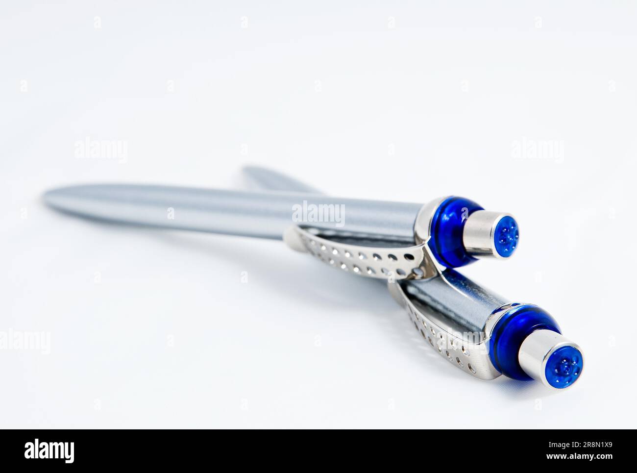 Silver biros on white background Stock Photo - Alamy