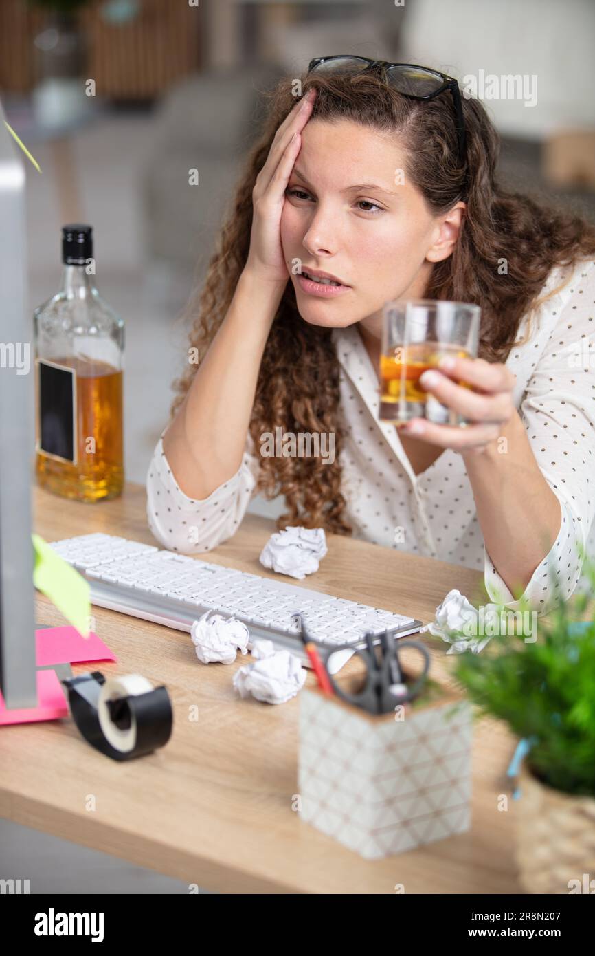alcoholic business woman drinks at work Stock Photo - Alamy