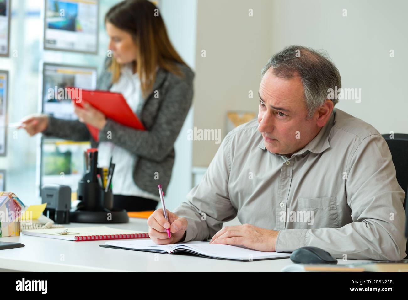 office worker in real office thinking Stock Photo - Alamy