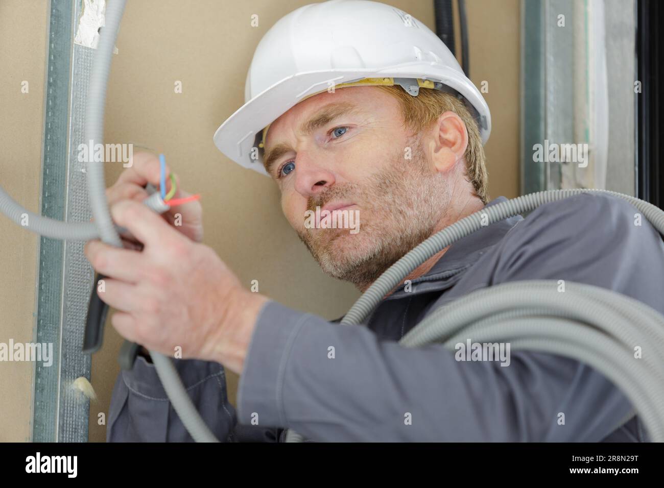 electrician installing cables in ceiling Stock Photo - Alamy