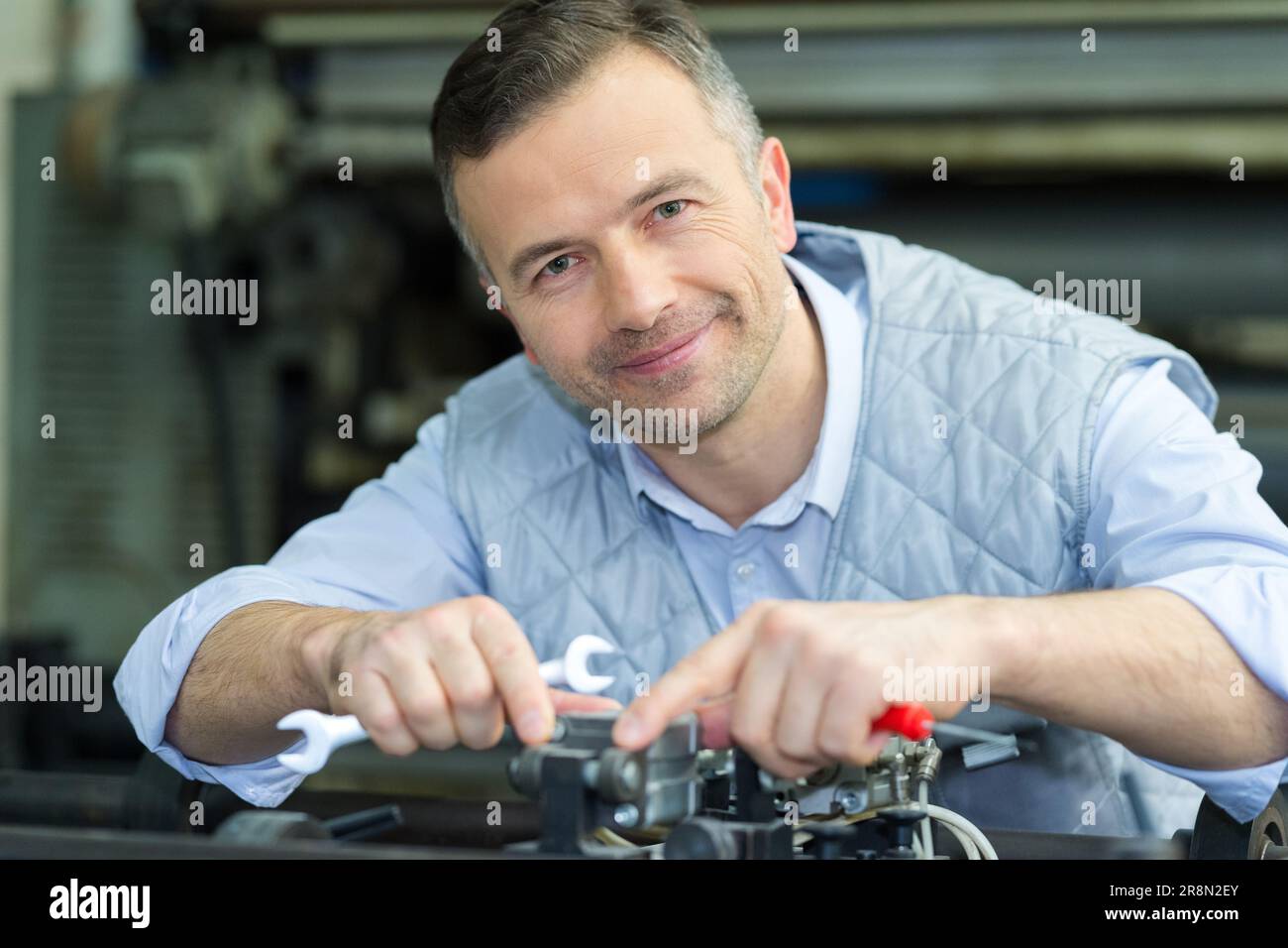 worker posing while working Stock Photo - Alamy