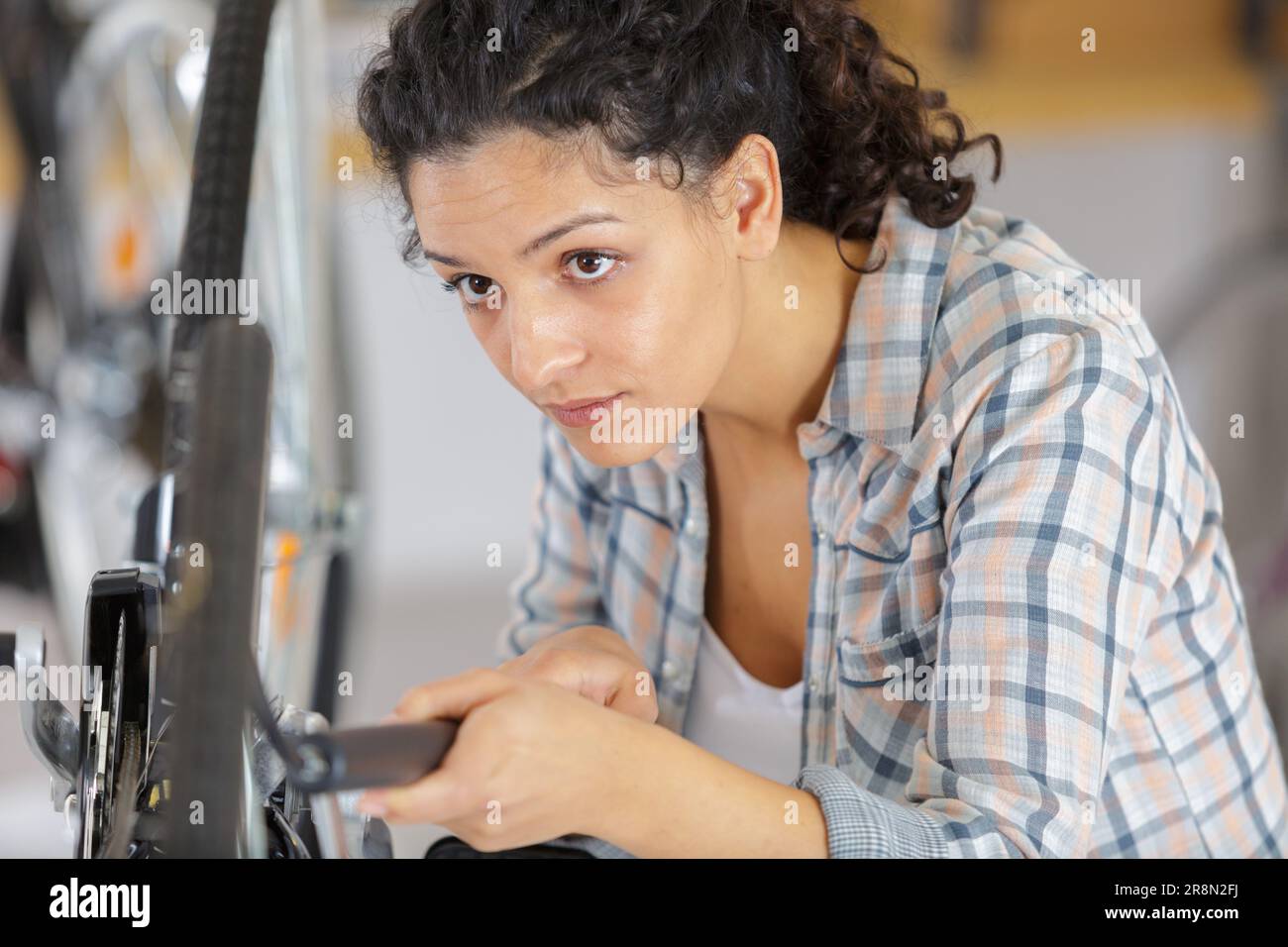 woman fixing bike brake with allen key kit Stock Photo - Alamy