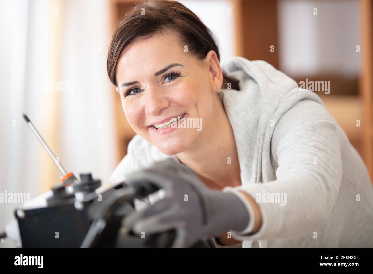 Female electrician fixing socket hi-res stock photography and images ...