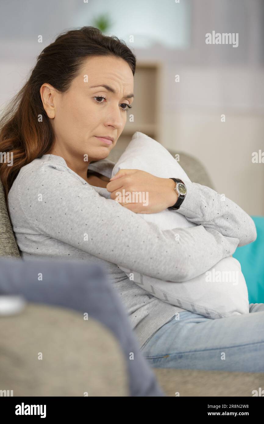 a sad girl hugging pillow Stock Photo - Alamy