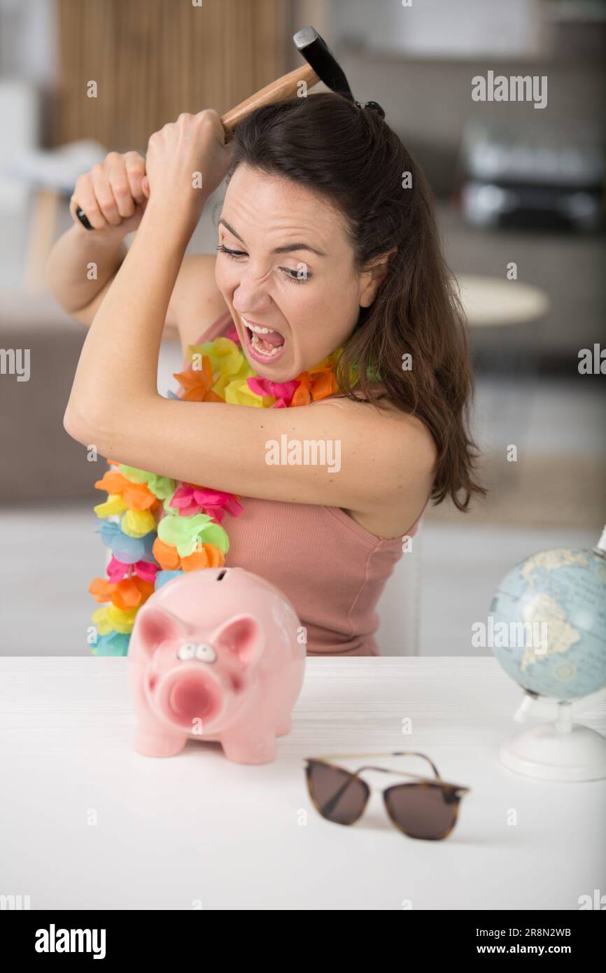 woman is breaking piggy money bank Stock Photo - Alamy