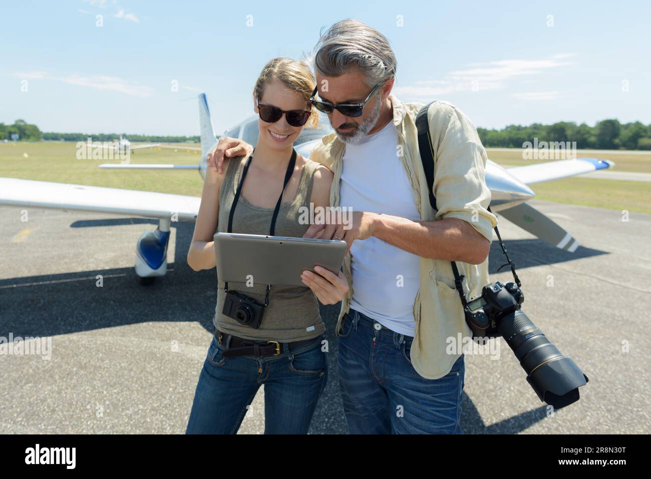 businessman and wife checking something in tablet Stock Photo - Alamy