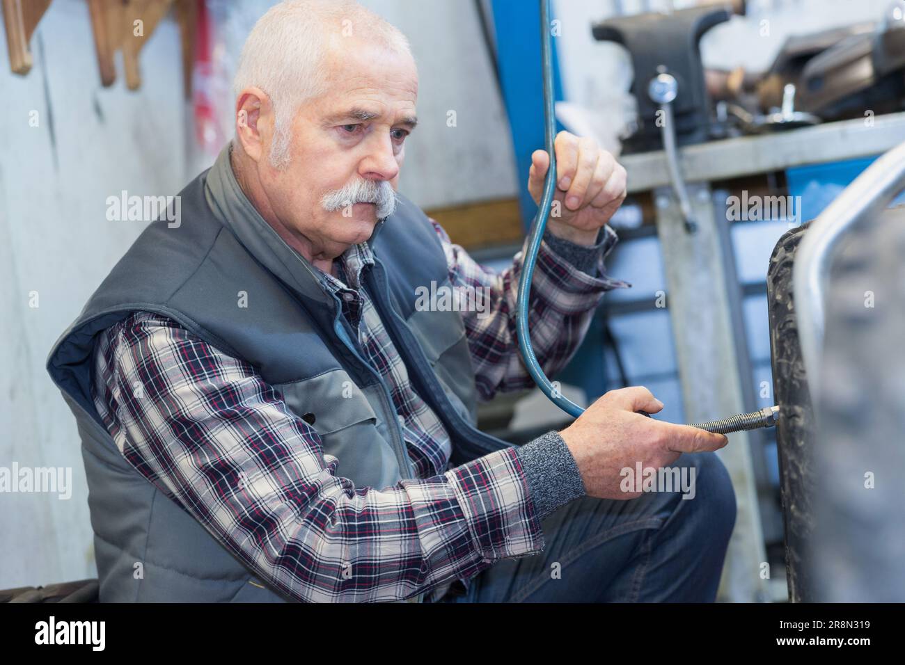 senior mechanic works on vehicle Stock Photo - Alamy