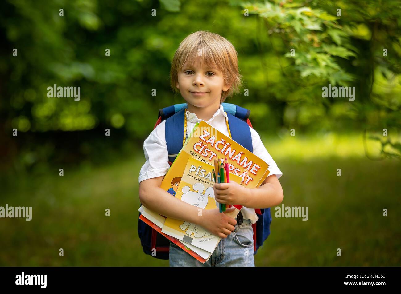 Cute preschool child, wearing school backpack, holding notebook and ...